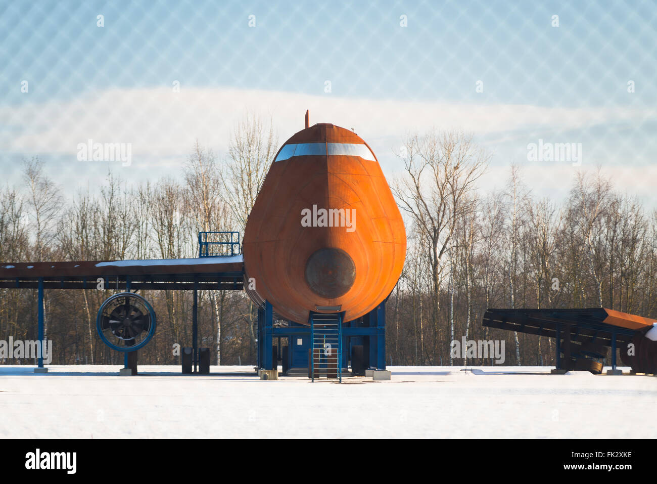 Large aircraft dummy for firefighter training behind a chain link fence ...