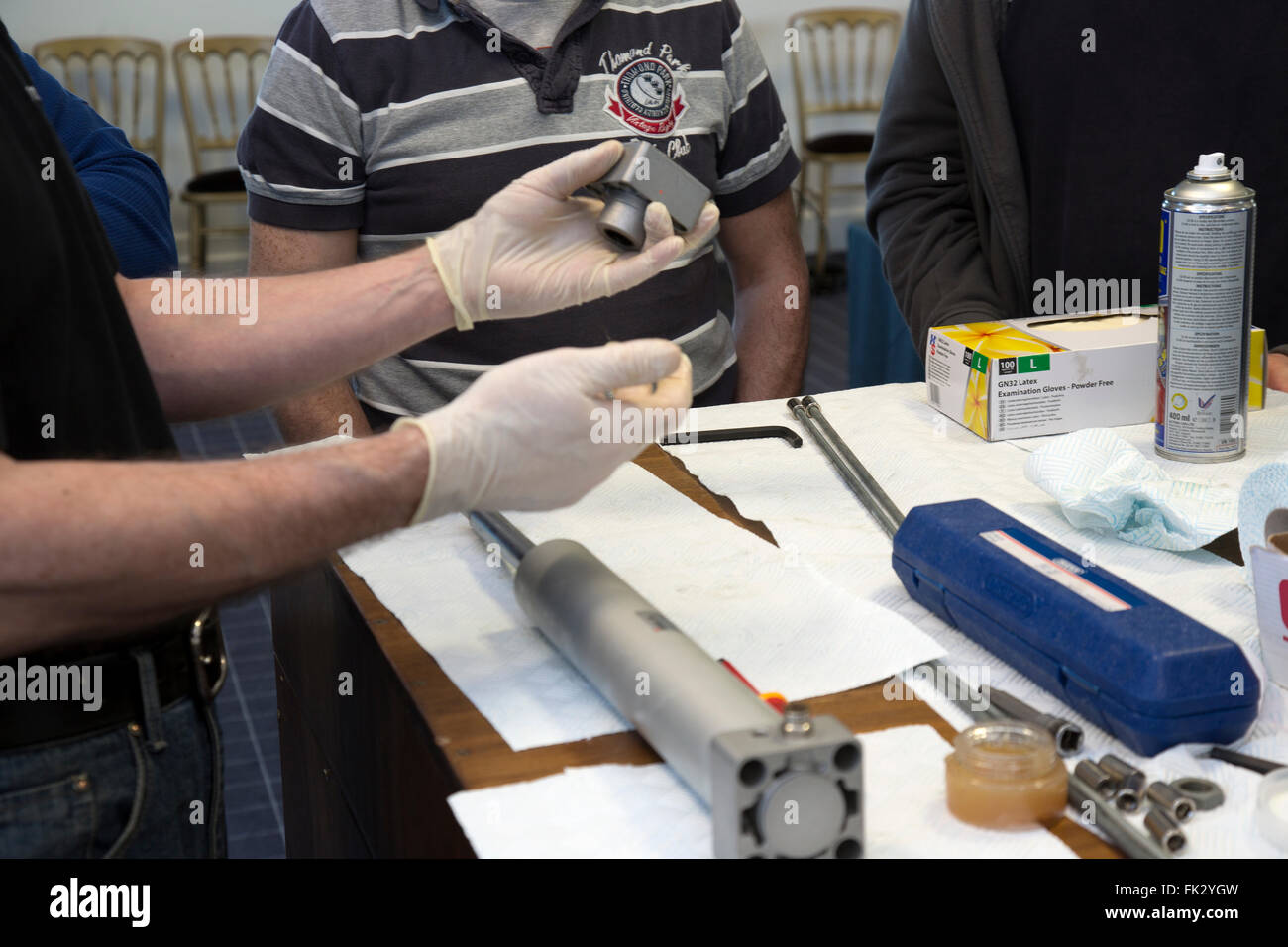 Engineering instructor wearing rubber gloves and holding tool Stock ...