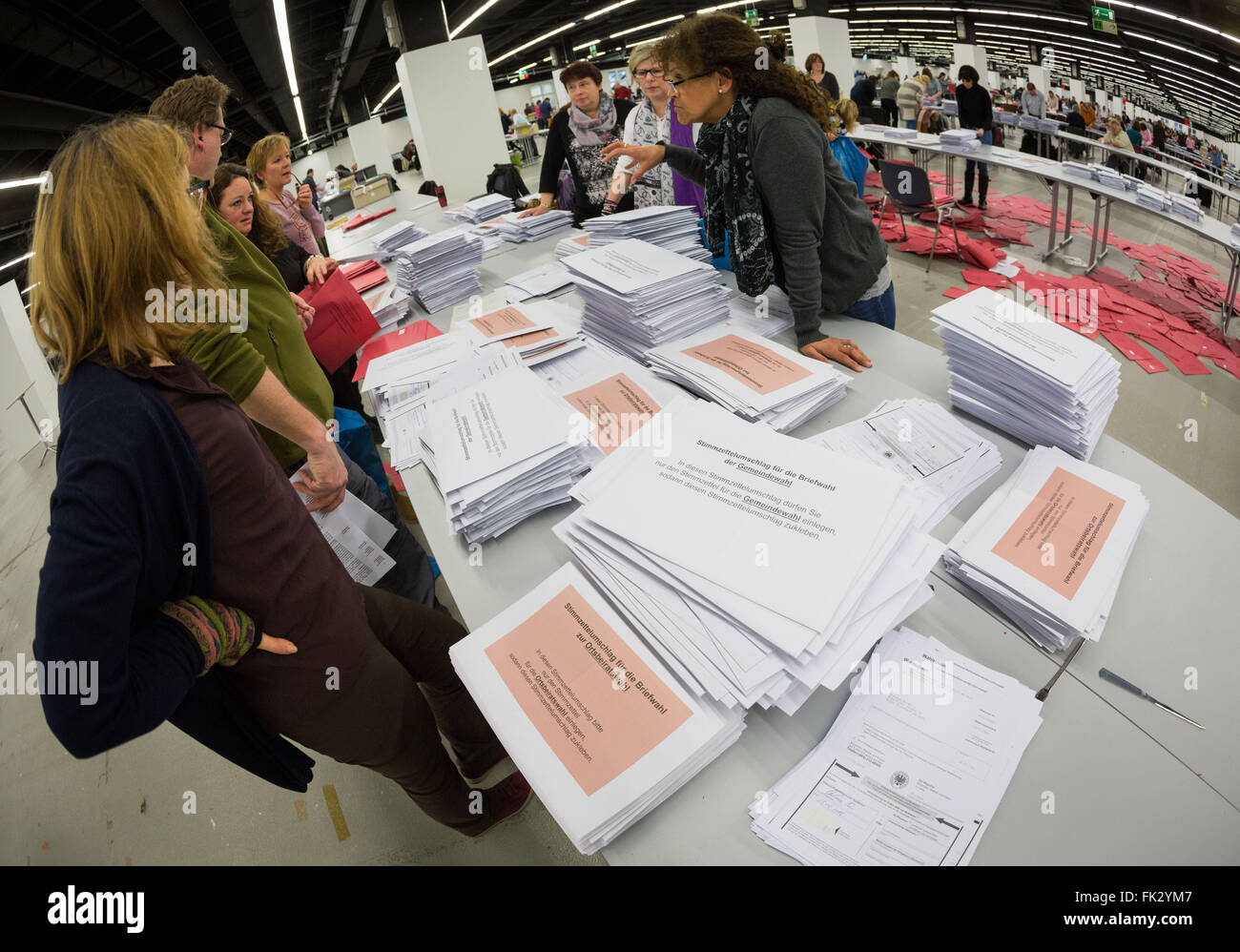 Helpers stand next to stacks of ballots cast by Frankfurt's absentee ...