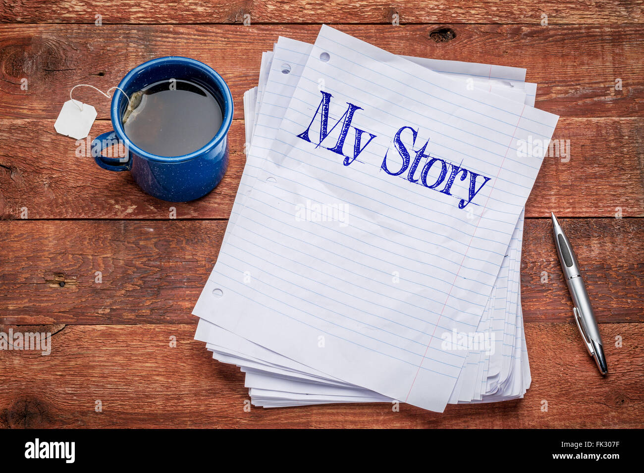 my story handwriting - stack of paper sheets on a rustic wood table ...