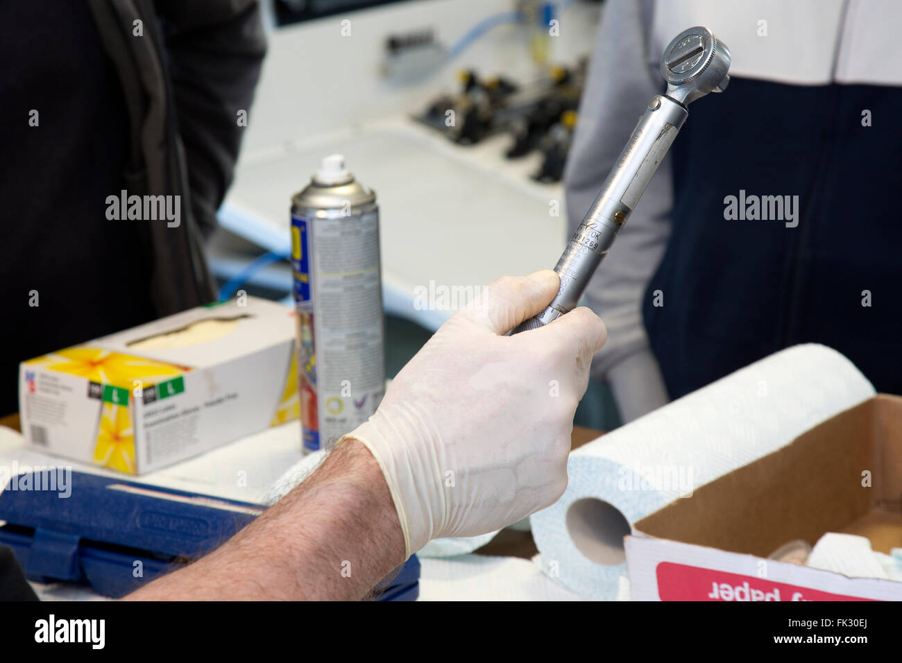 Engineering instructor wearing rubber gloves and holding tool Stock ...