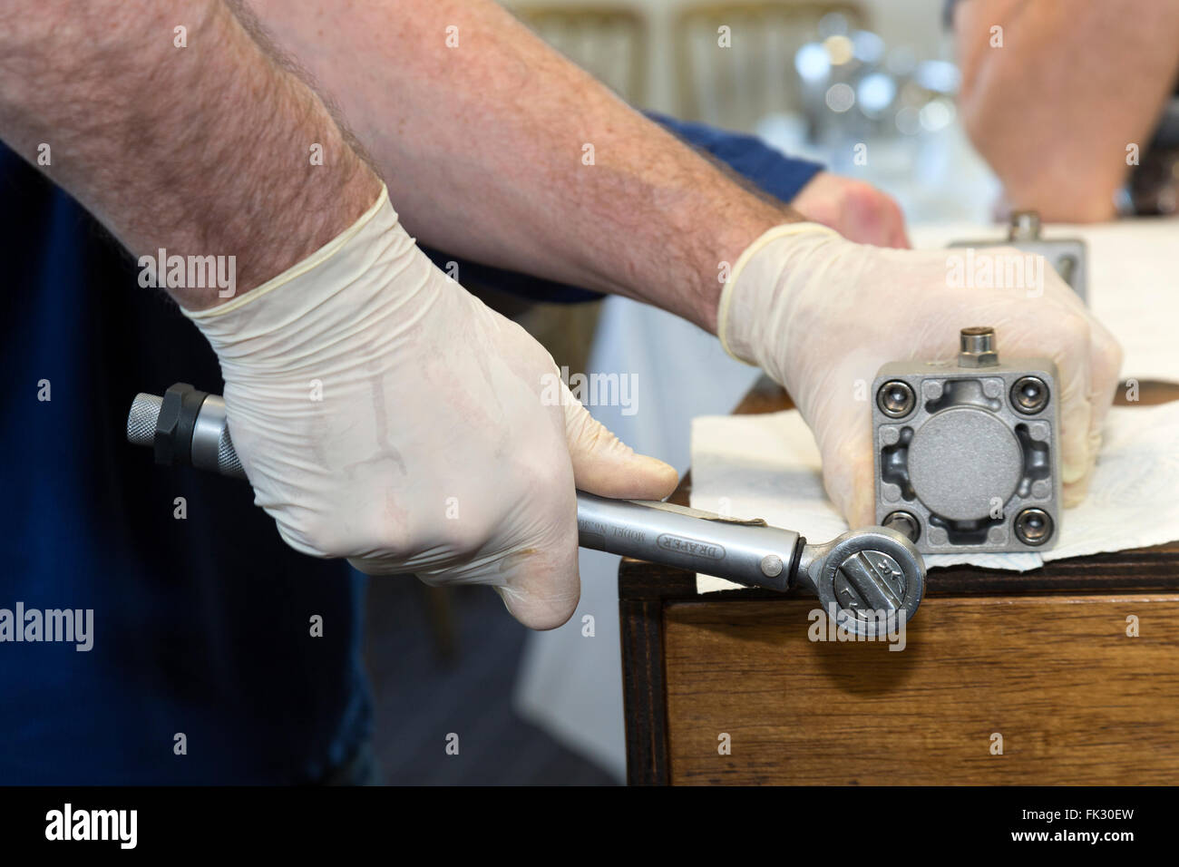 Engineering instructor wearing rubber gloves and holding tool Stock ...