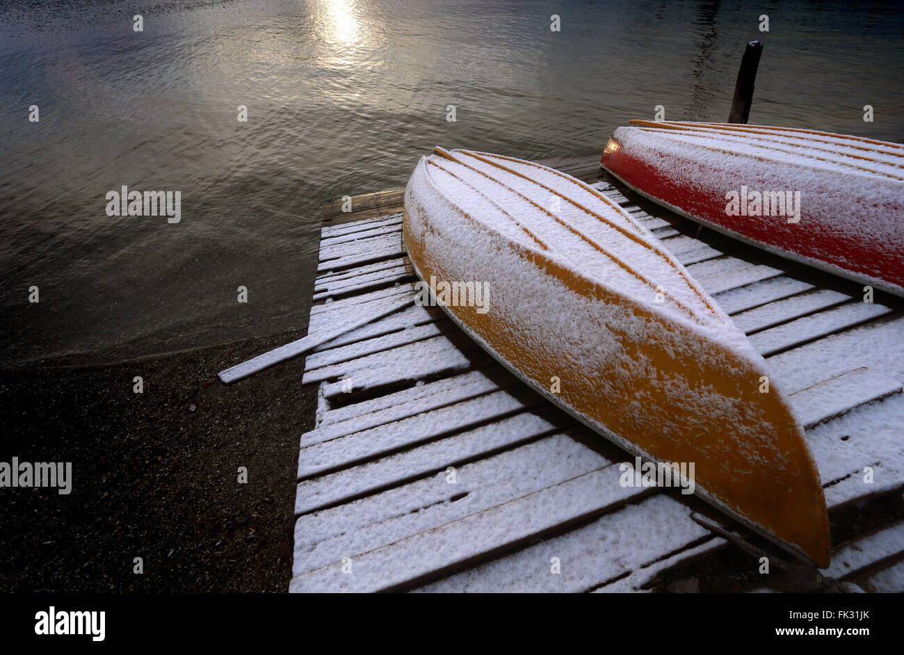 Utting, Germany. 06th Mar, 2016. Rowing boats covered by snow pictured ...