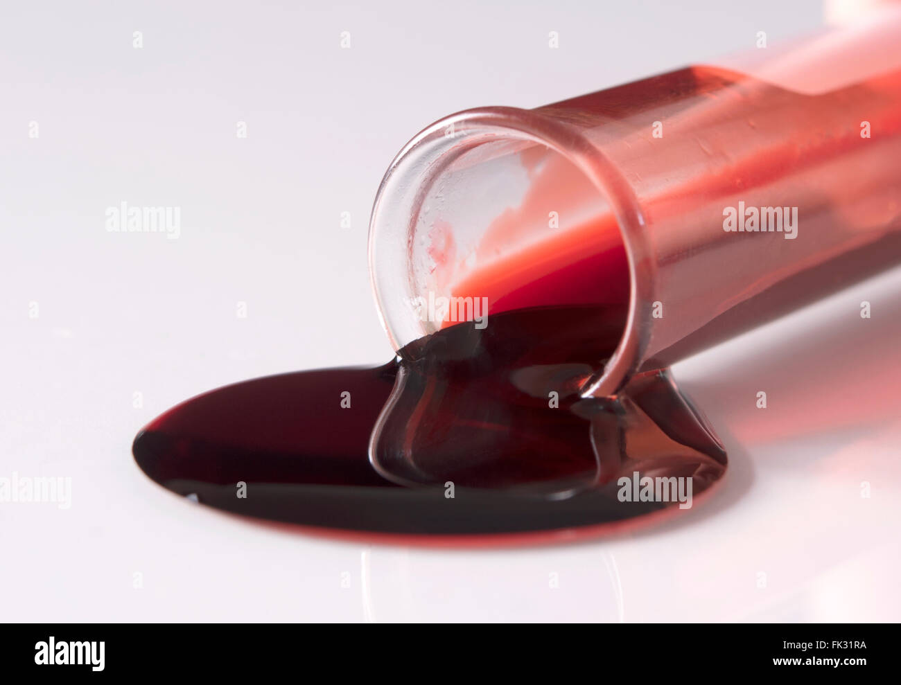 close up of blood spilling from test tube Stock Photo - Alamy