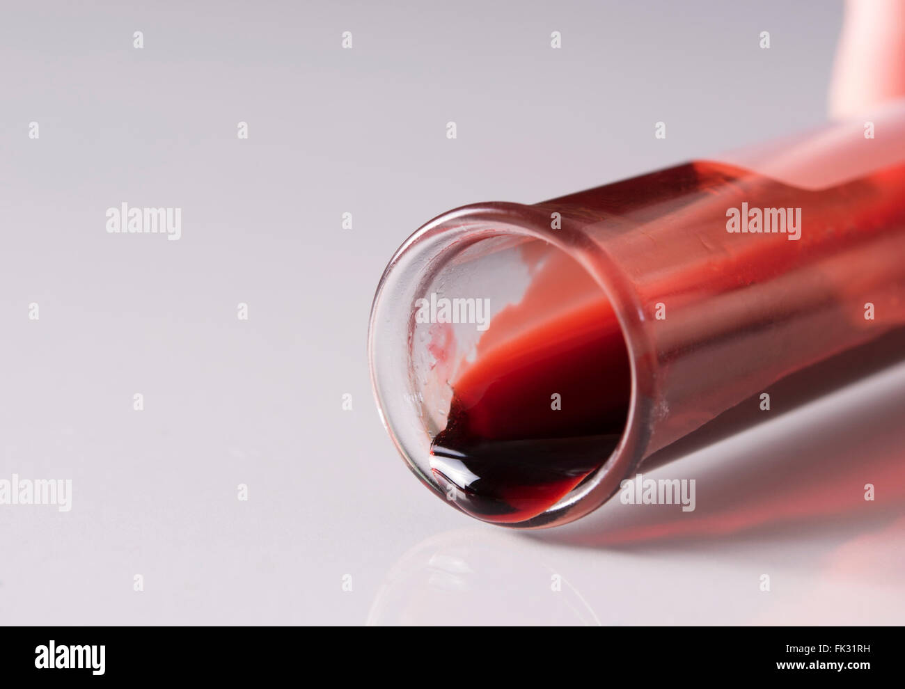 close up of blood spilling from test tube Stock Photo - Alamy