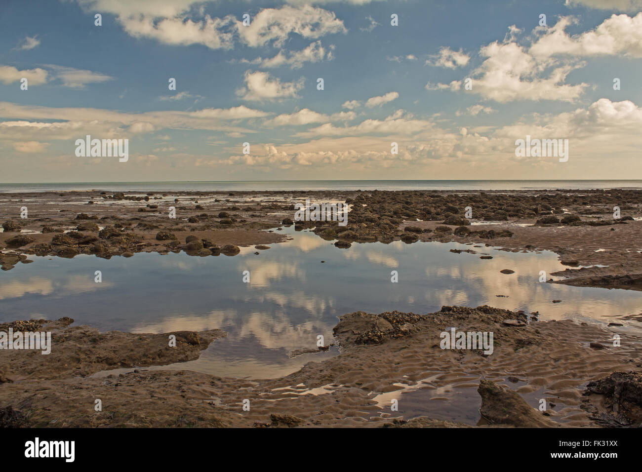 Sea and sky reflection on beach Stock Photo - Alamy