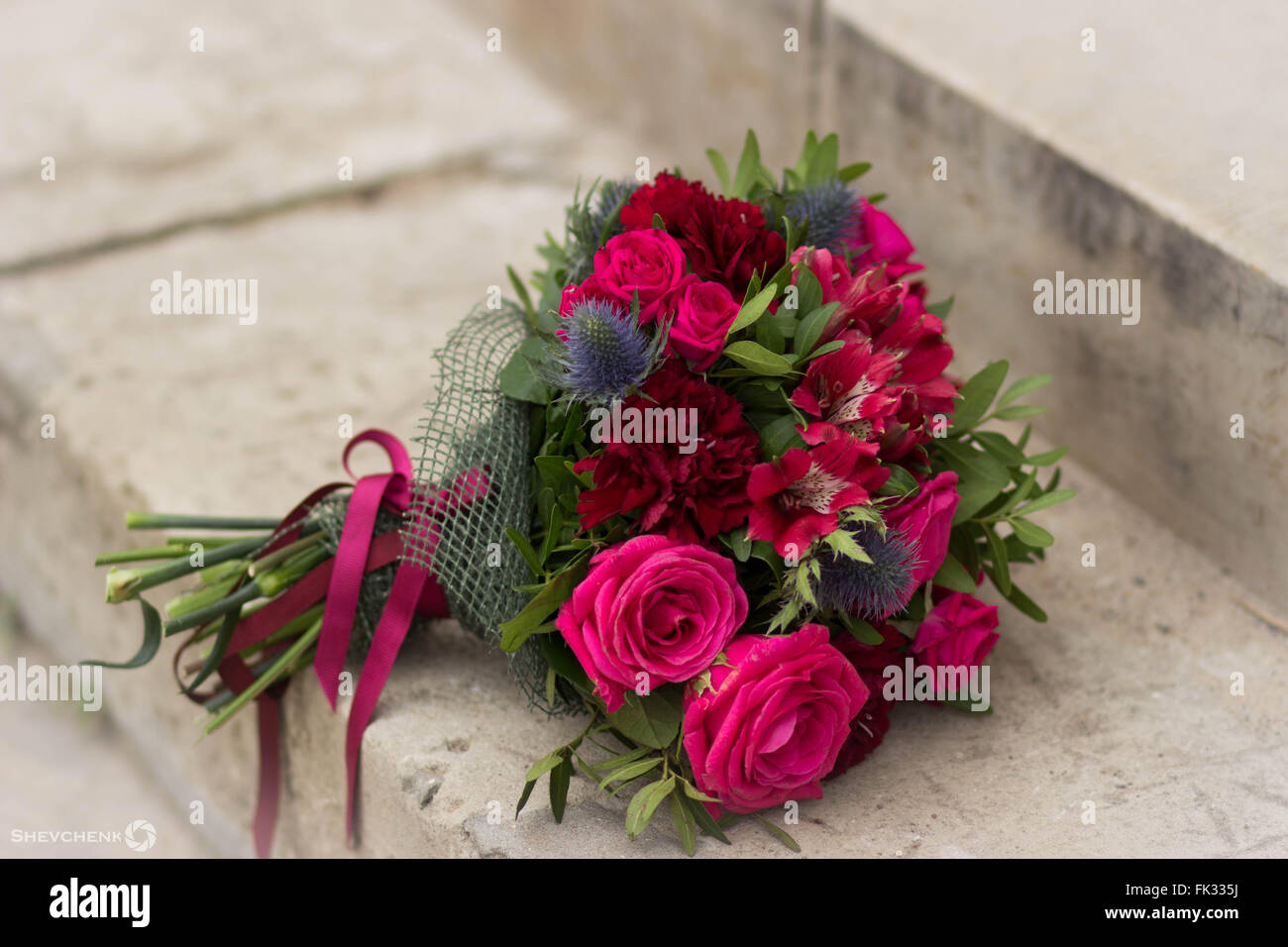 Bouquet of pink flowers on stone stairs Stock Photo - Alamy