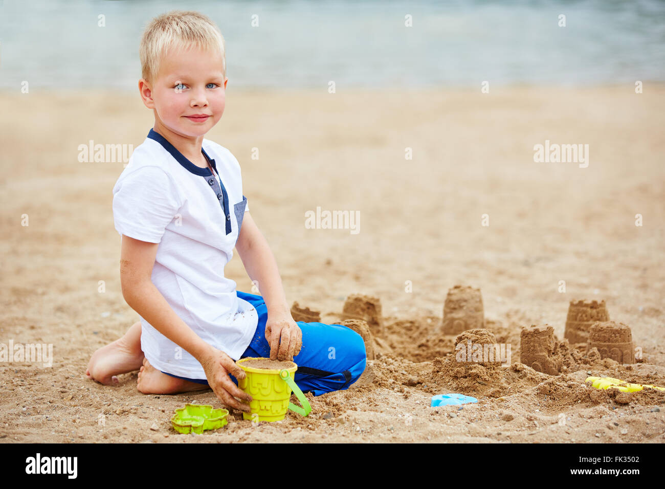 Boy building sandcastle on beach hi-res stock photography and images ...