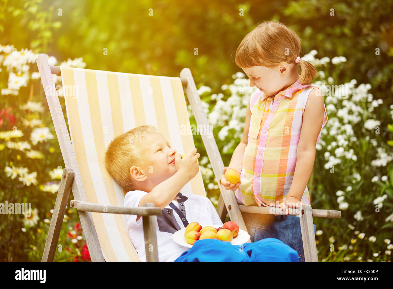 Siblings play together in garden hi-res stock photography and images ...