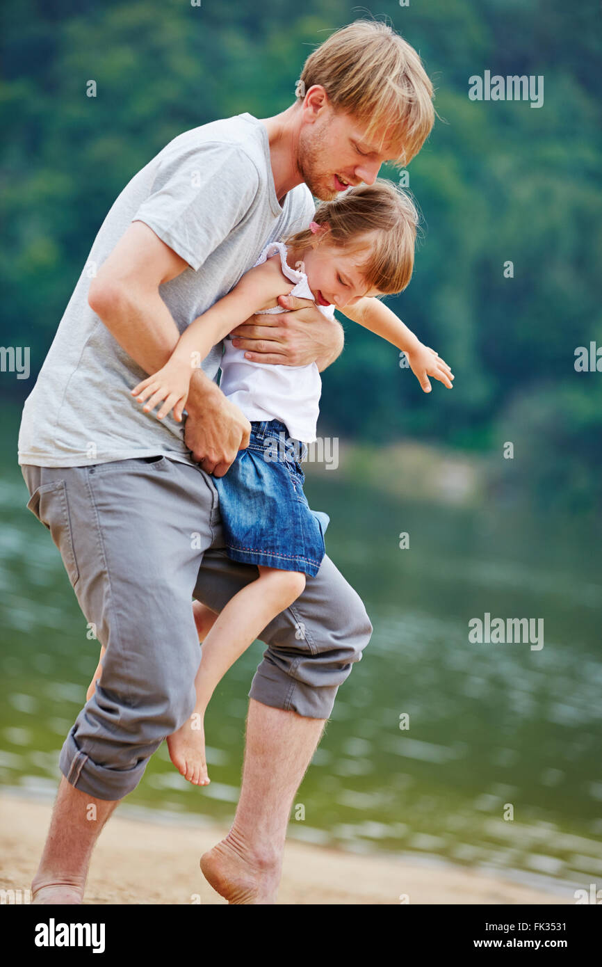 Father carrying daughter on the beach hi-res stock photography and images - Alamy