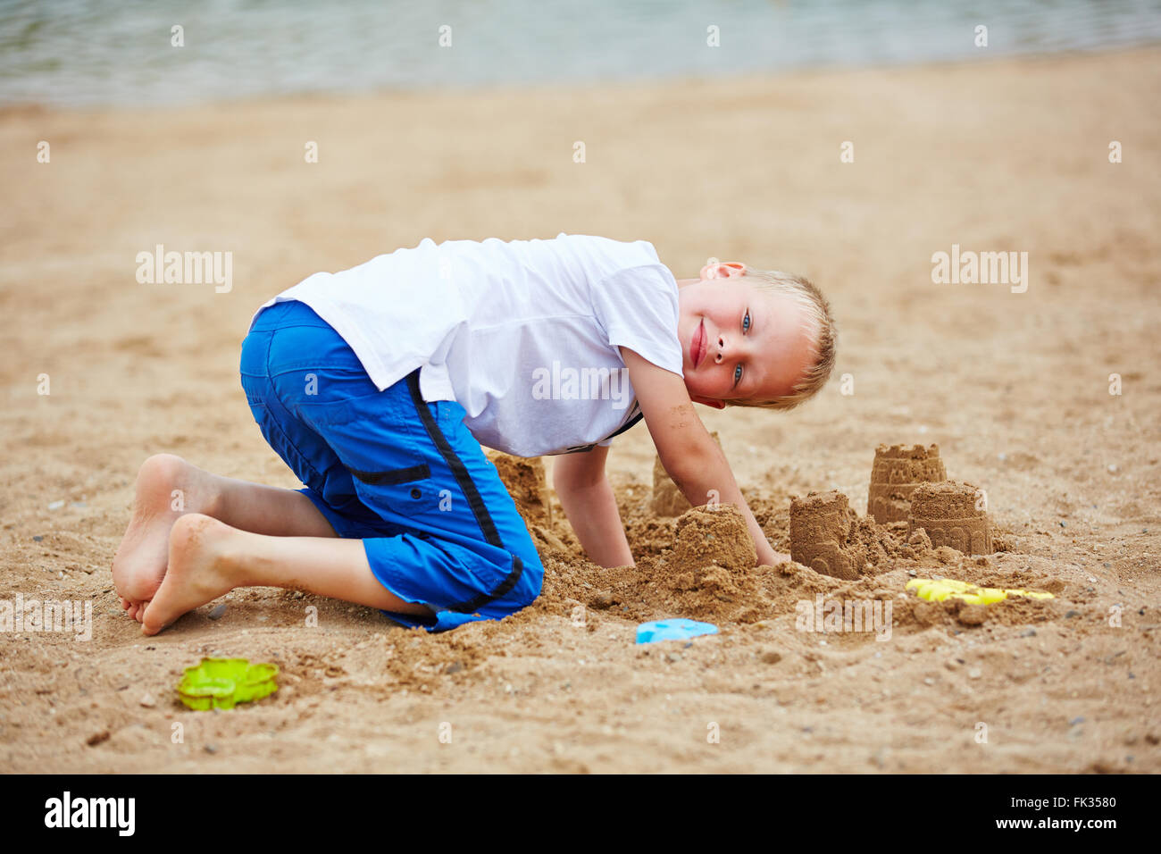 Boy building sandcastle on beach hi-res stock photography and images ...
