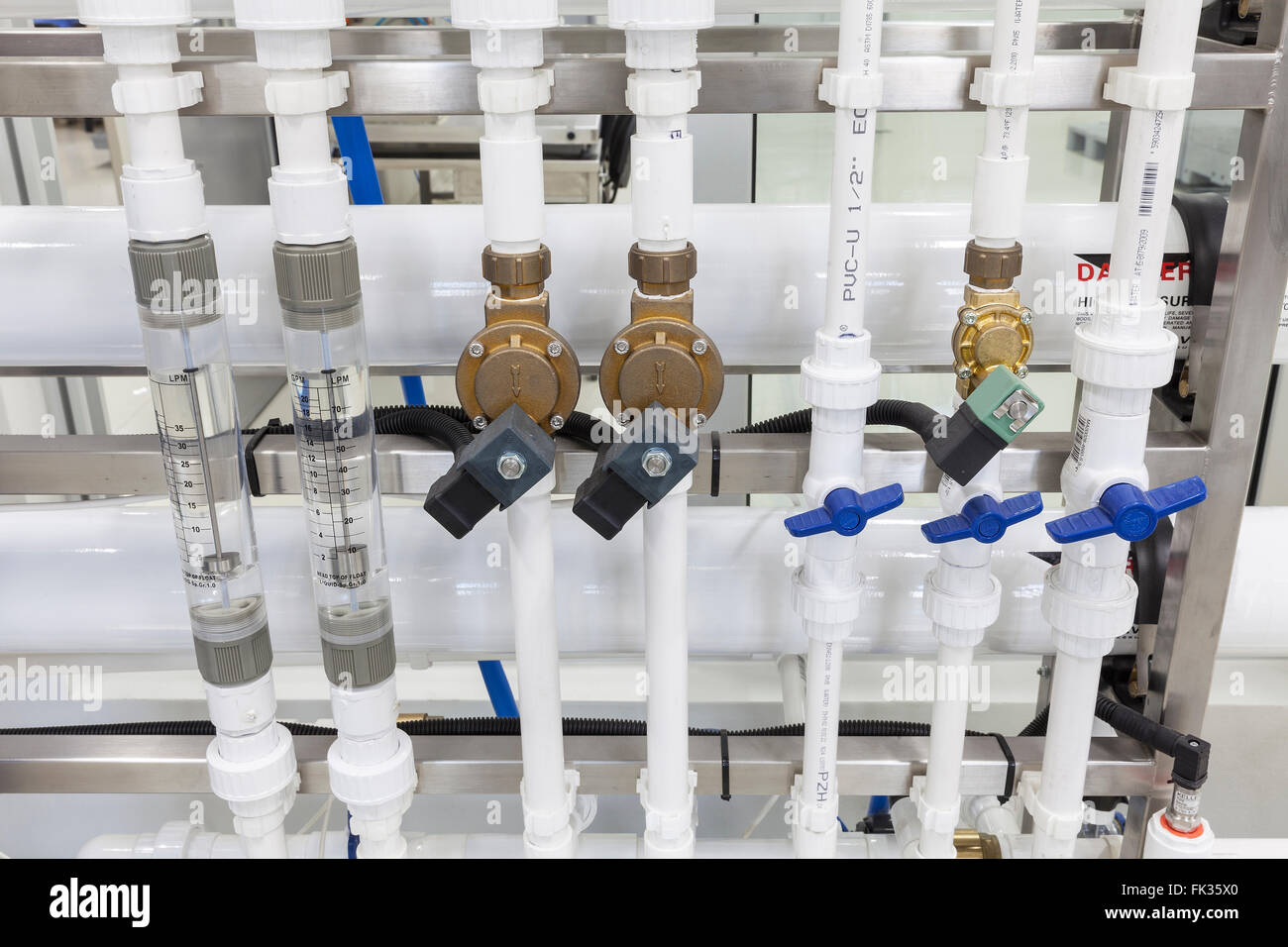 installation of white plastic pipes with valves Stock Photo - Alamy