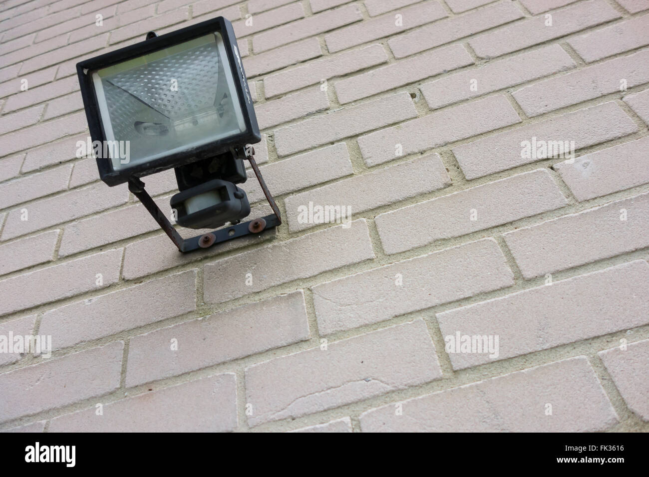 Security lamp with PIR mounted high on brick wall Stock Photo - Alamy