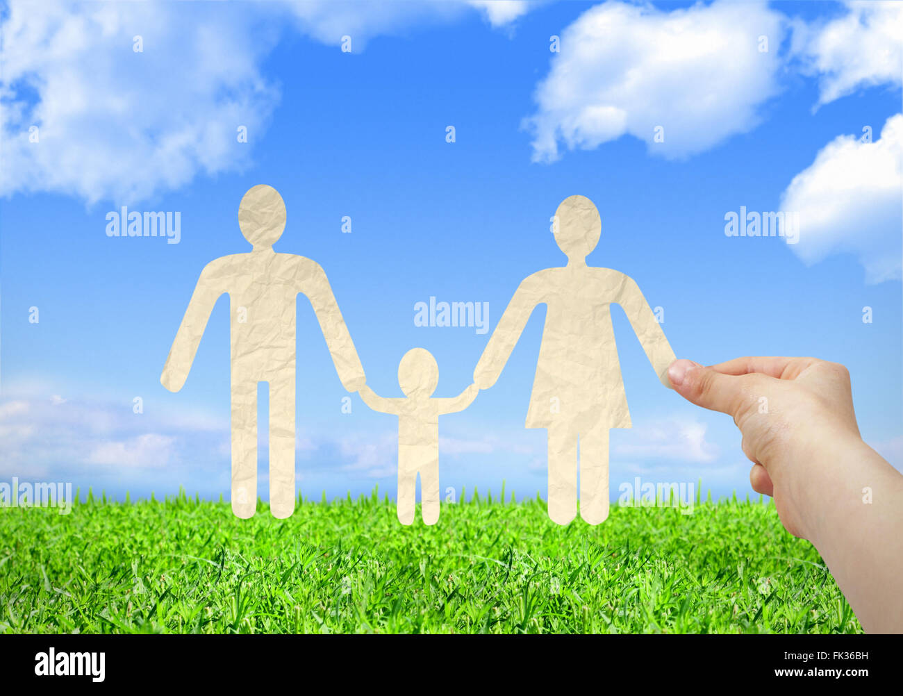 Hand holding paper cut family with sky background Stock Photo - Alamy