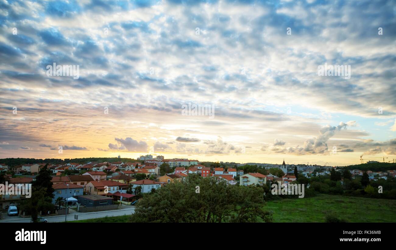 Sunset over village Stock Photo - Alamy