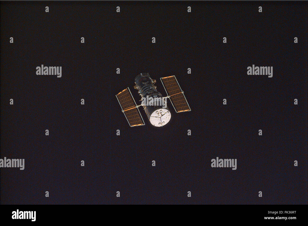 The Hubble Space Telescope floats toward the Space Shuttle Discovery as ...