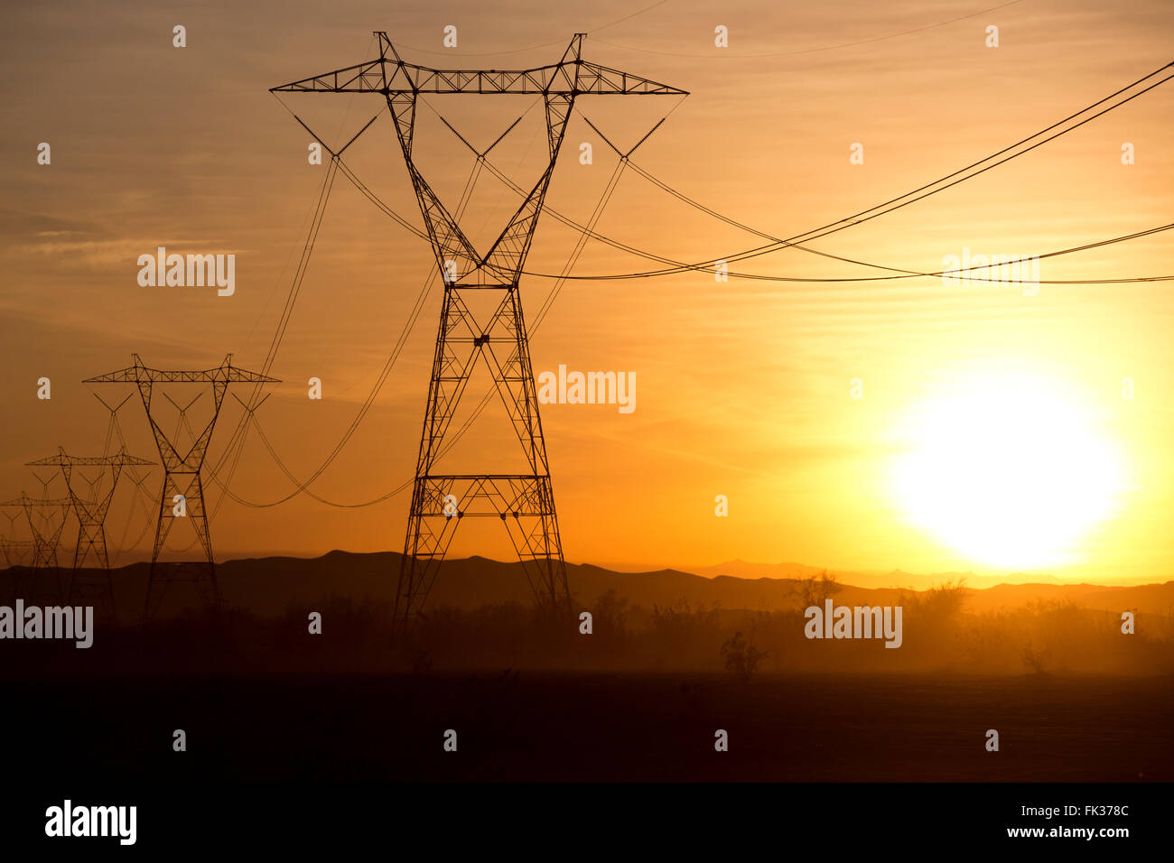 High tension power lines and the setting sun in the Sonoran Desert ...