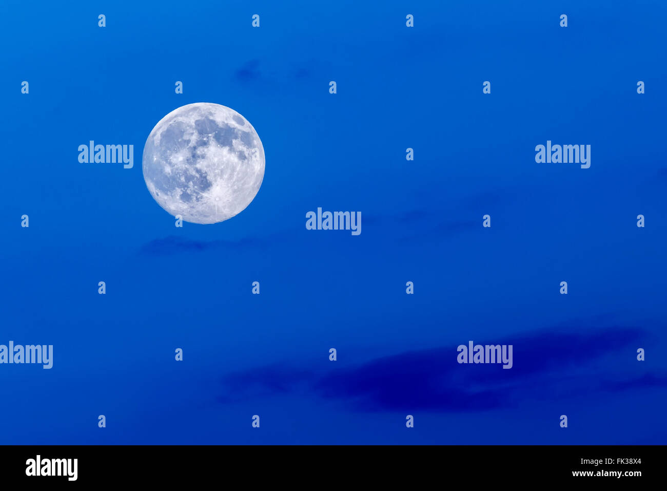 Full blue moon at blue sky background Stock Photo - Alamy
