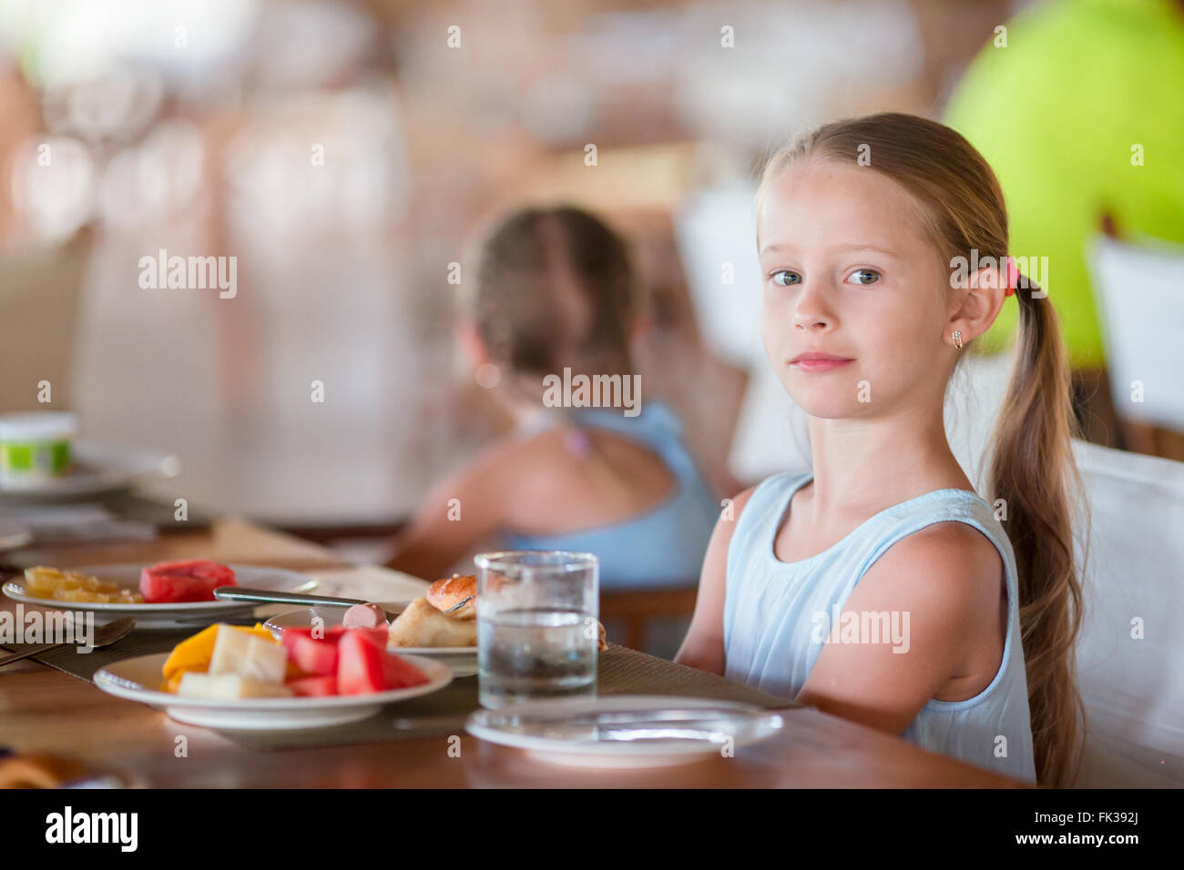 Adorable little girl having breakfast at outdoor cafe Stock Photo - Alamy