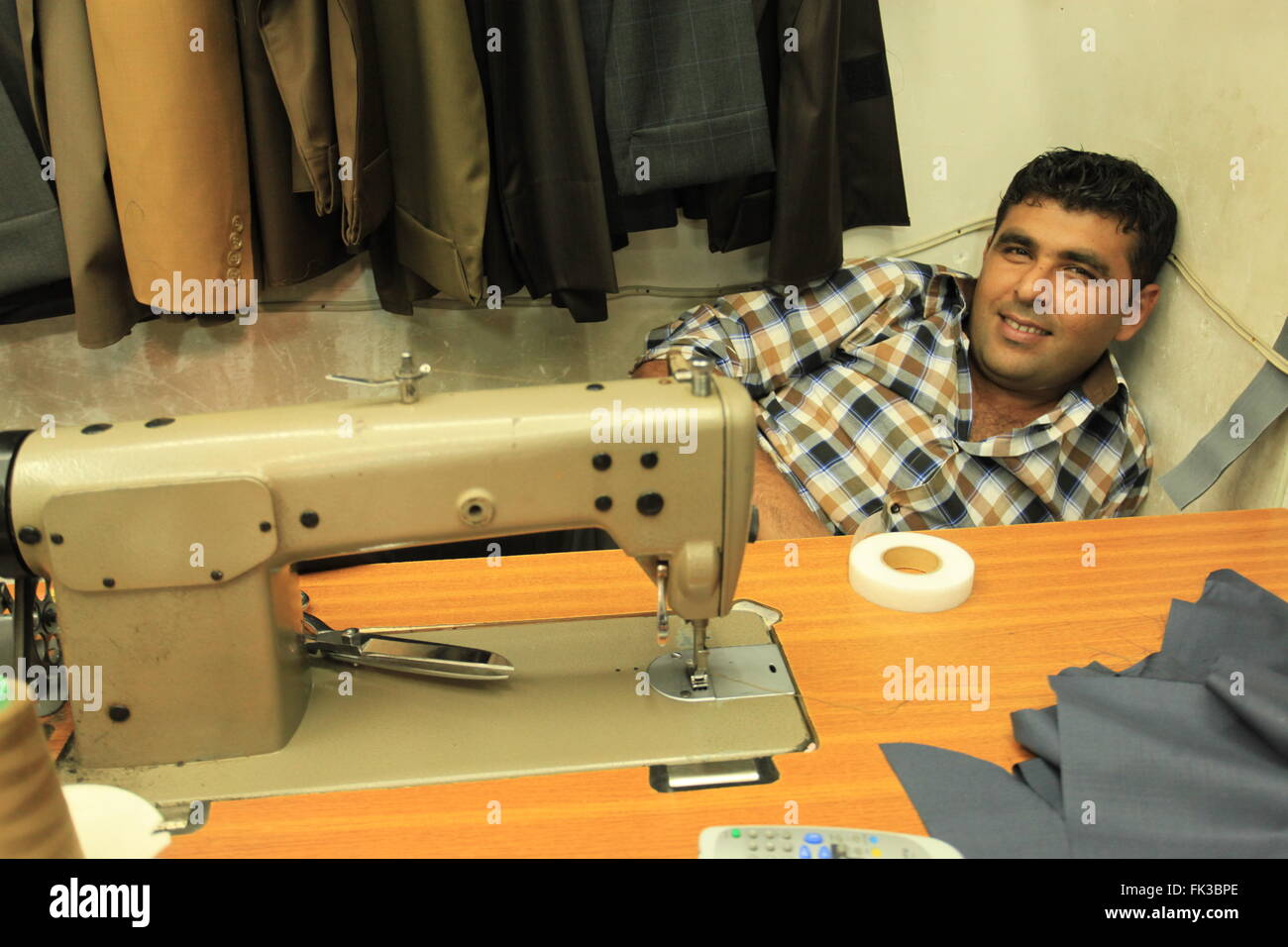 A Kurdish tailor in his relaxing in his workshop at Erbil bazaar Stock ...
