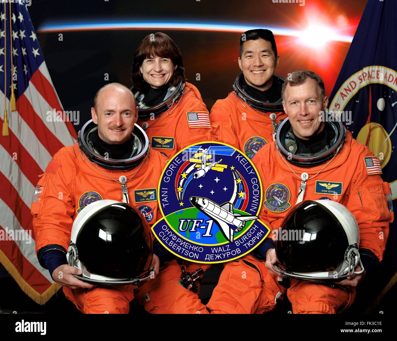 Group portrait of the STS-108 space shuttle crew astronauts in orange ...