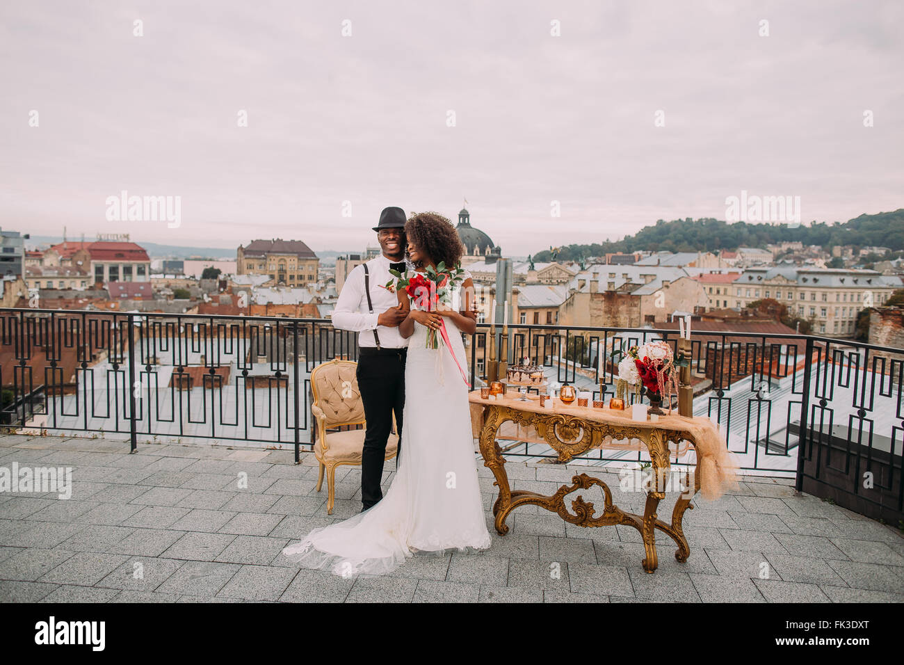 Happy african bride and groom happily hugging on the terrace Stock ...