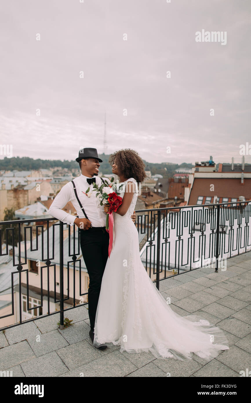 Beautiful african wedding couple lovingly look at each other on the ...