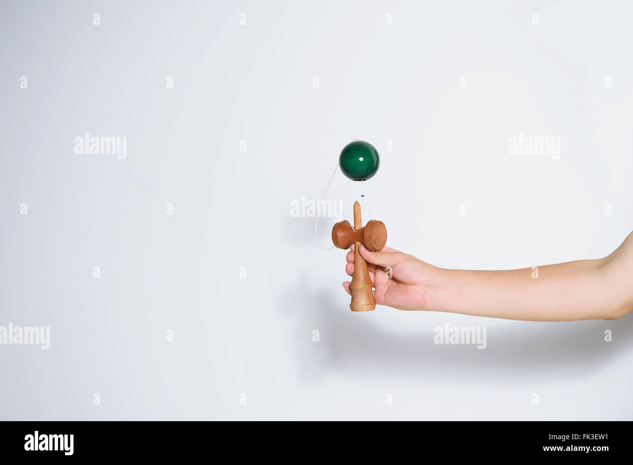 Japanese young man playing with Kendama Stock Photo - Alamy