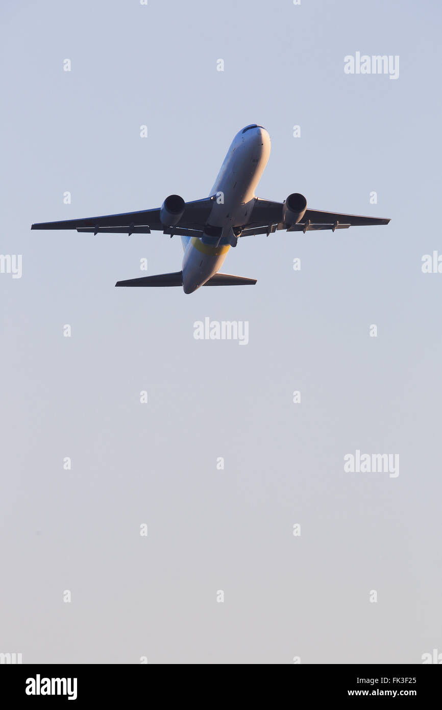 Airplane flying in the sky Stock Photo - Alamy