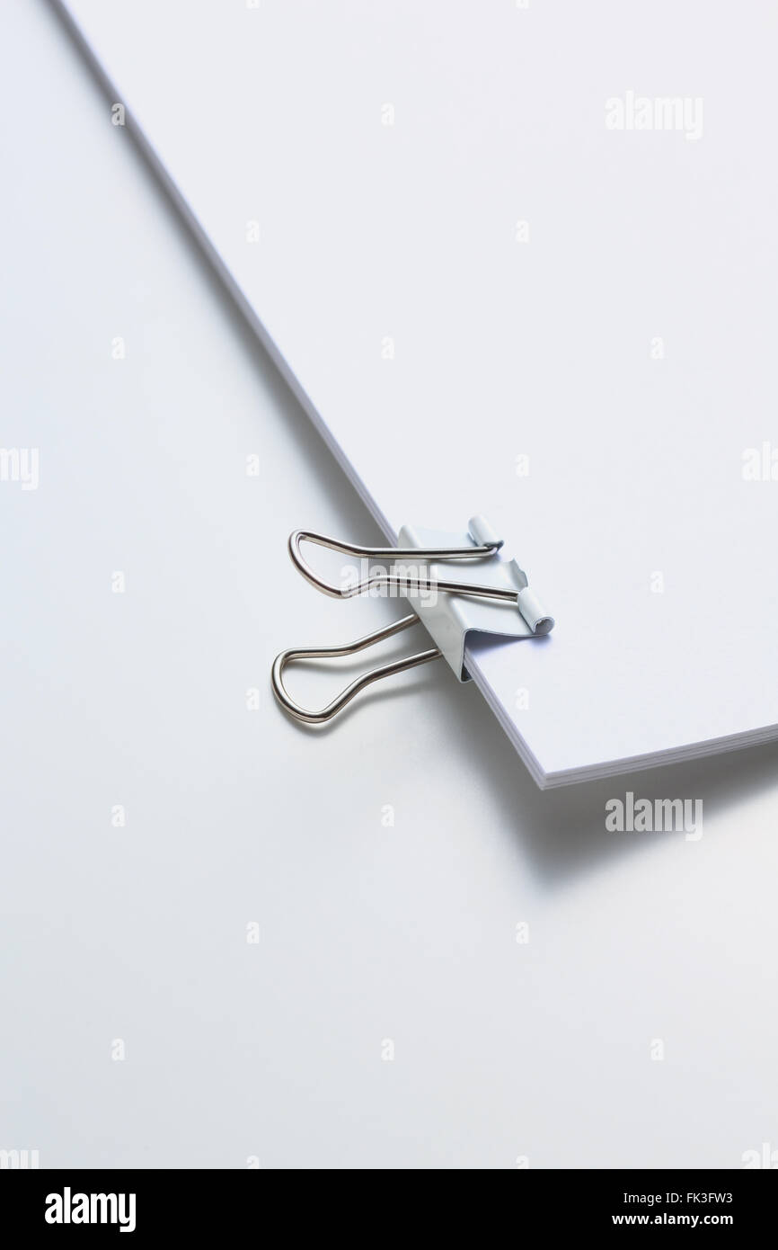 Alligator clip on paper Stock Photo - Alamy