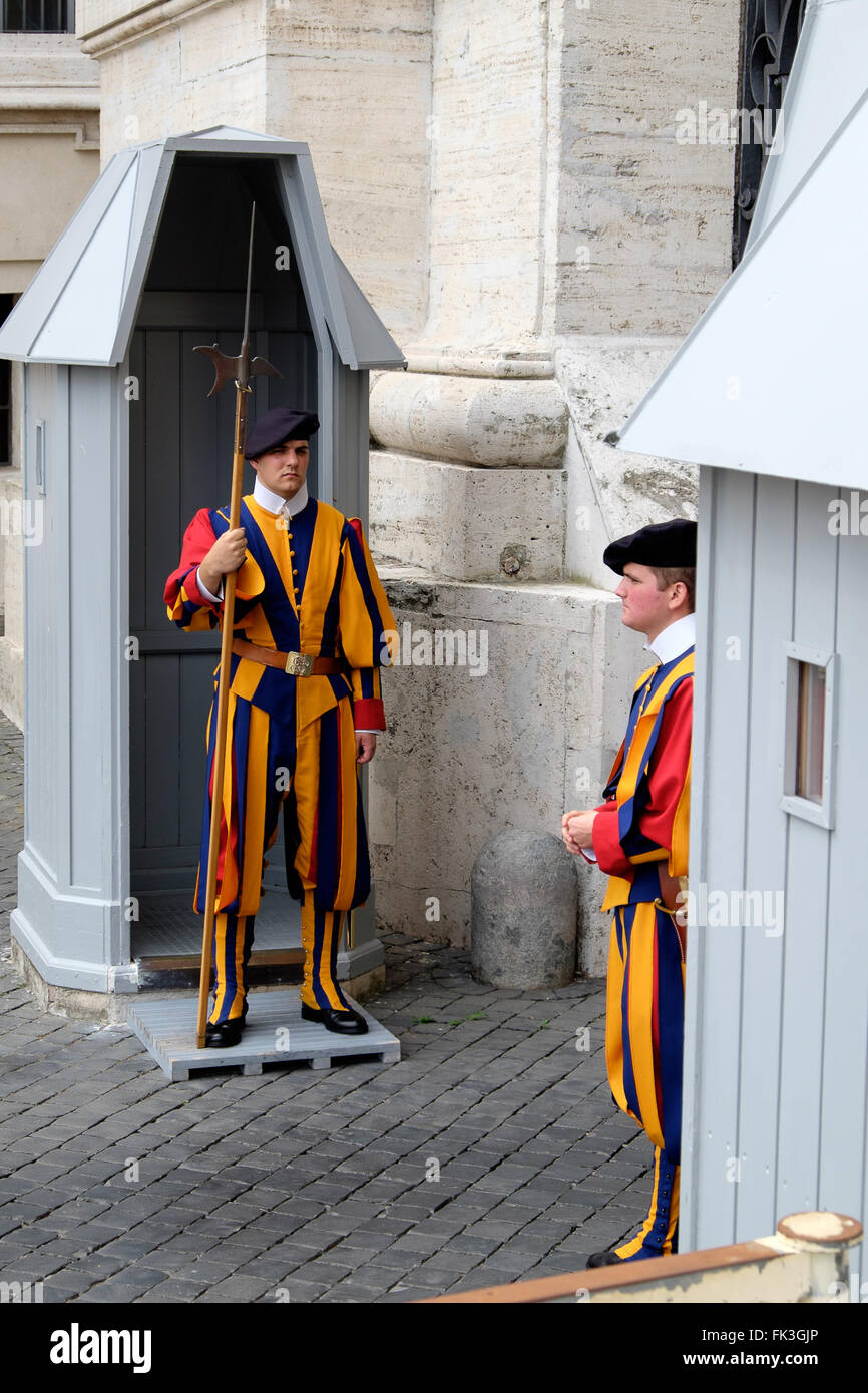 Two Swiss Guard soldiers stand at attention while guarding a gate at St ...