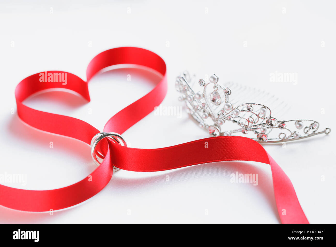 Red ribbon and wedding rings Stock Photo - Alamy