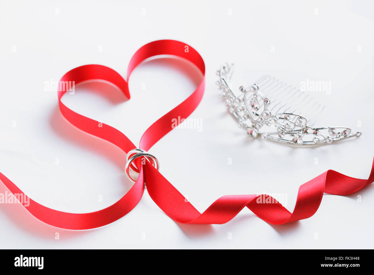 Red ribbon and wedding rings Stock Photo - Alamy