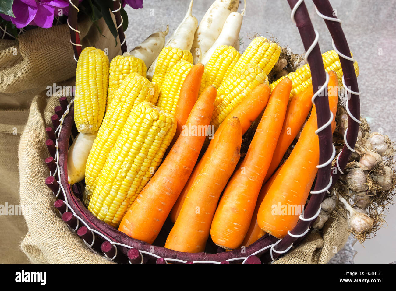 A photo of Multiple different vegetables in a basket Stock Photo - Alamy
