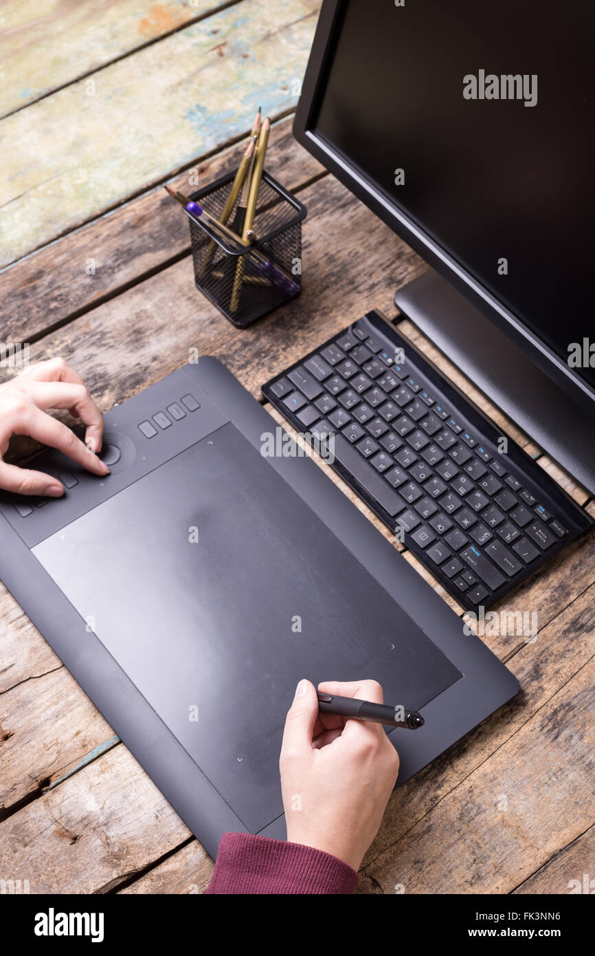 Workplace of graphic designer on wooden table. Artist drawing on ...