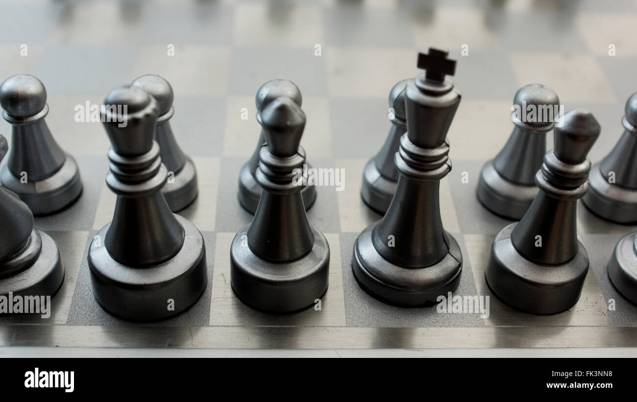 Light and dark wooden chess pieces on chess table. High resolution ...