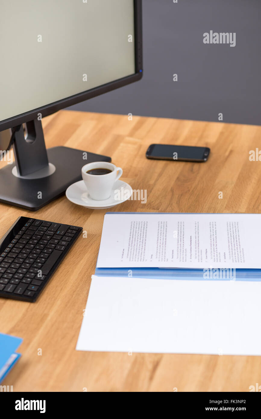 Business workplace background with computer, papers and cup of coffee ...