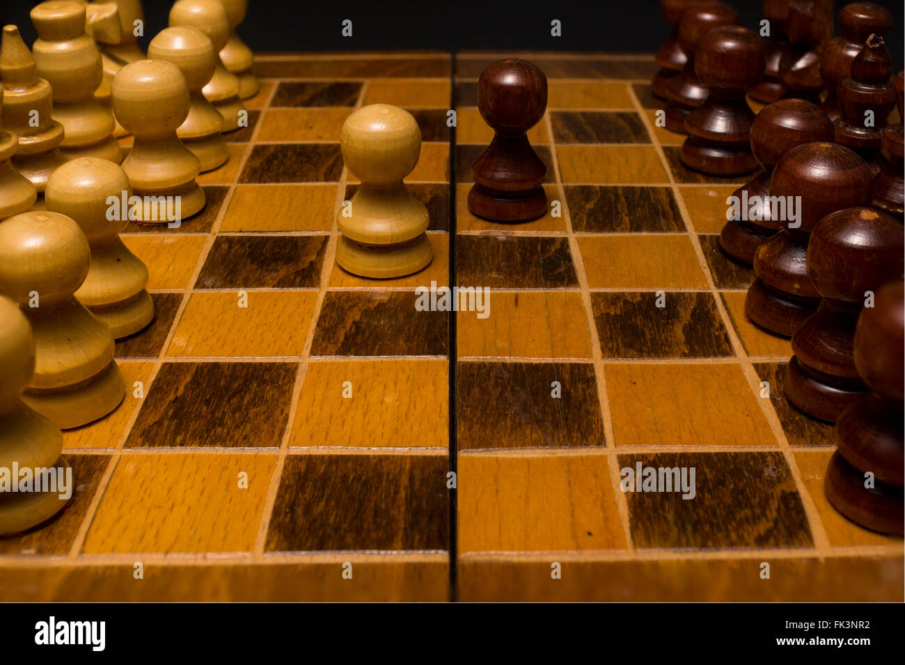 Light and dark wooden chess pieces on chess table. High resolution ...