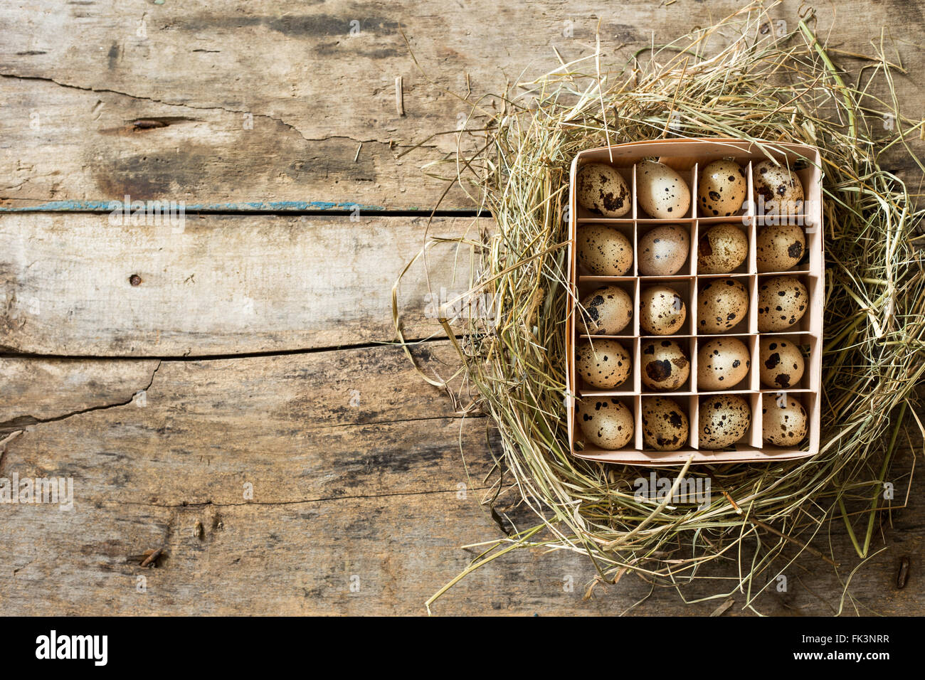 Easter wood background with box of quail eggs inside of hay nest Stock ...