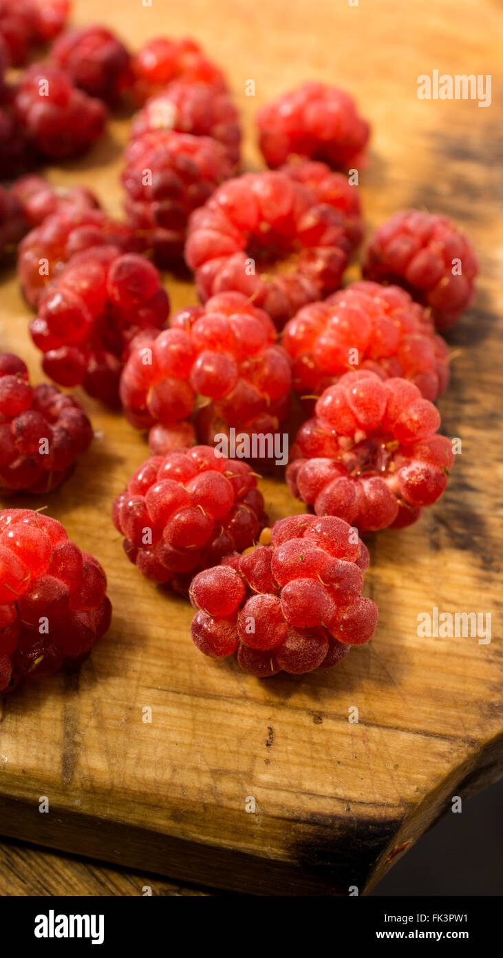 Red Raspberry on wooden chopping board and table. High resolution image ...