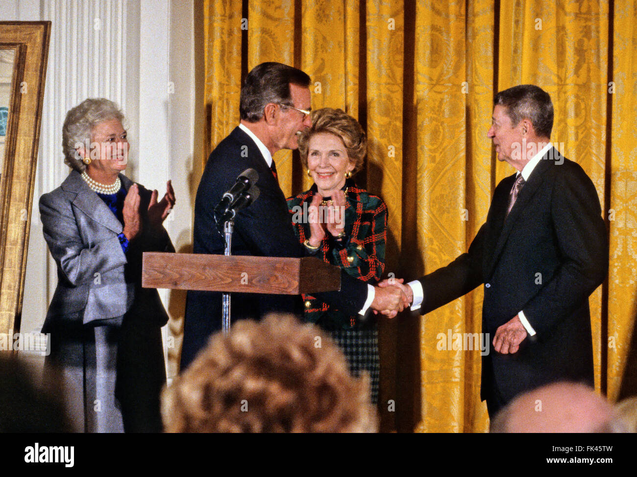 United States President George H.W. Bush shakes hands with former U.S ...