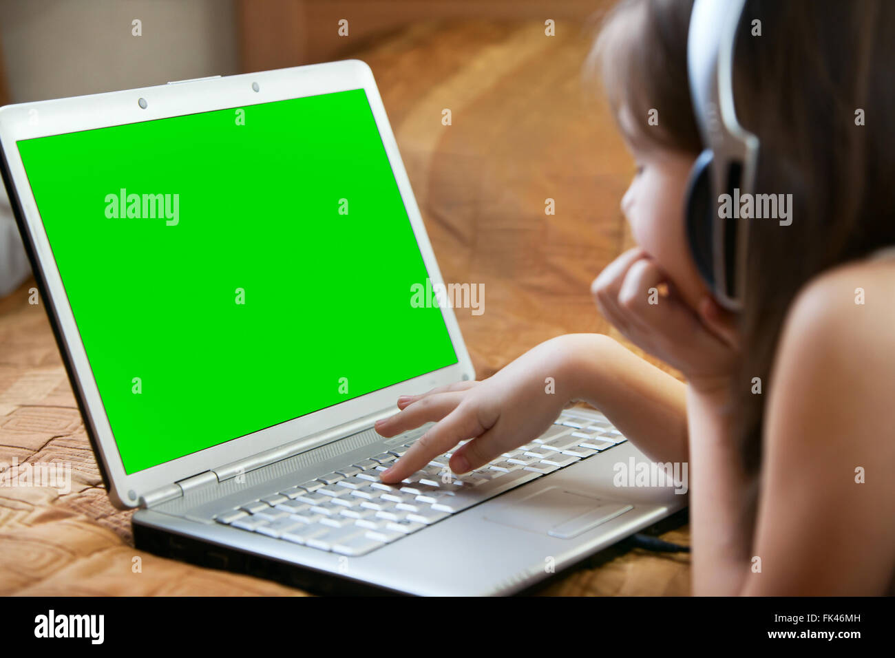 Kid's Hands typing keyboard on desk wood Stock Photo - Alamy