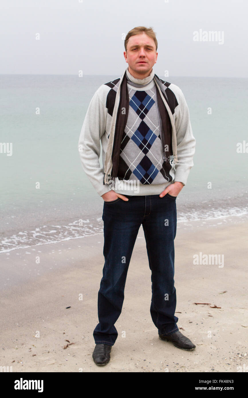 young man on sea background. autumn beach Stock Photo - Alamy