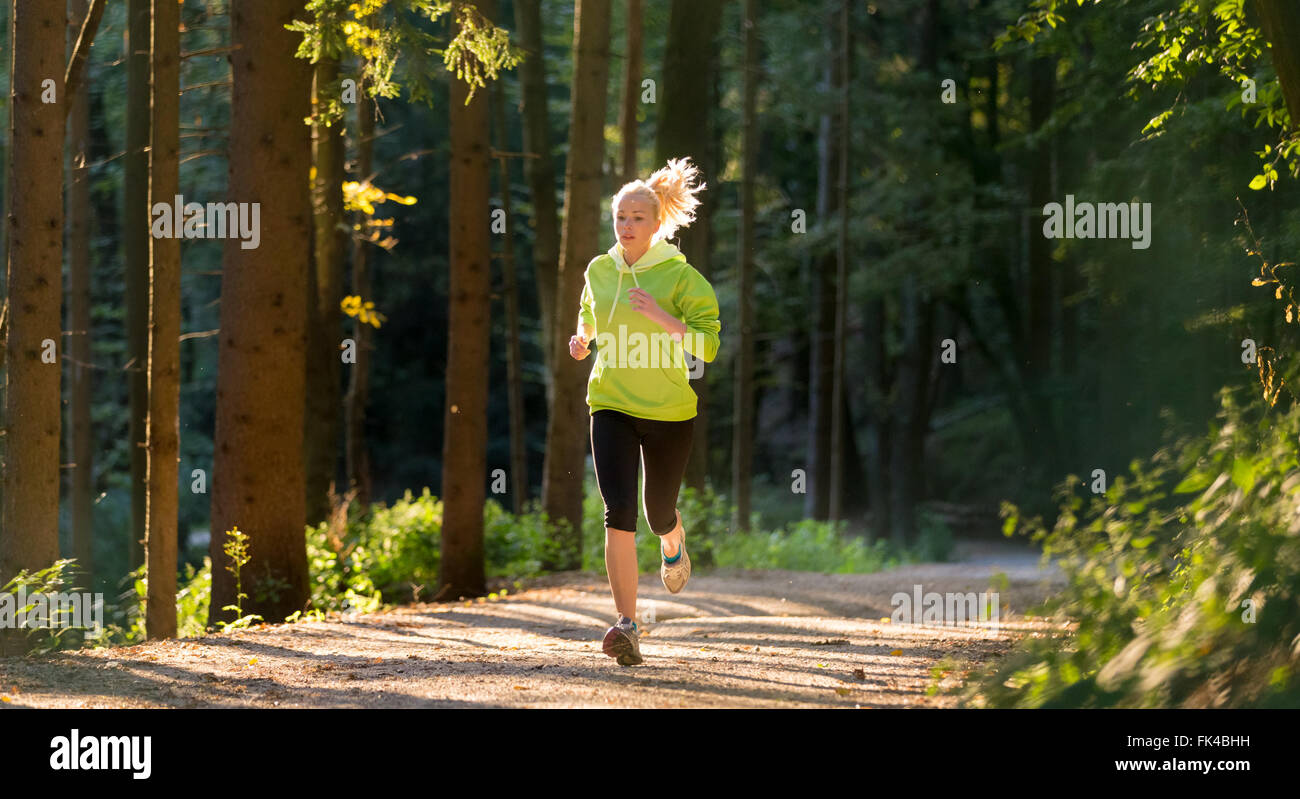 Pretty young girl runner in the forest Stock Photo - Alamy