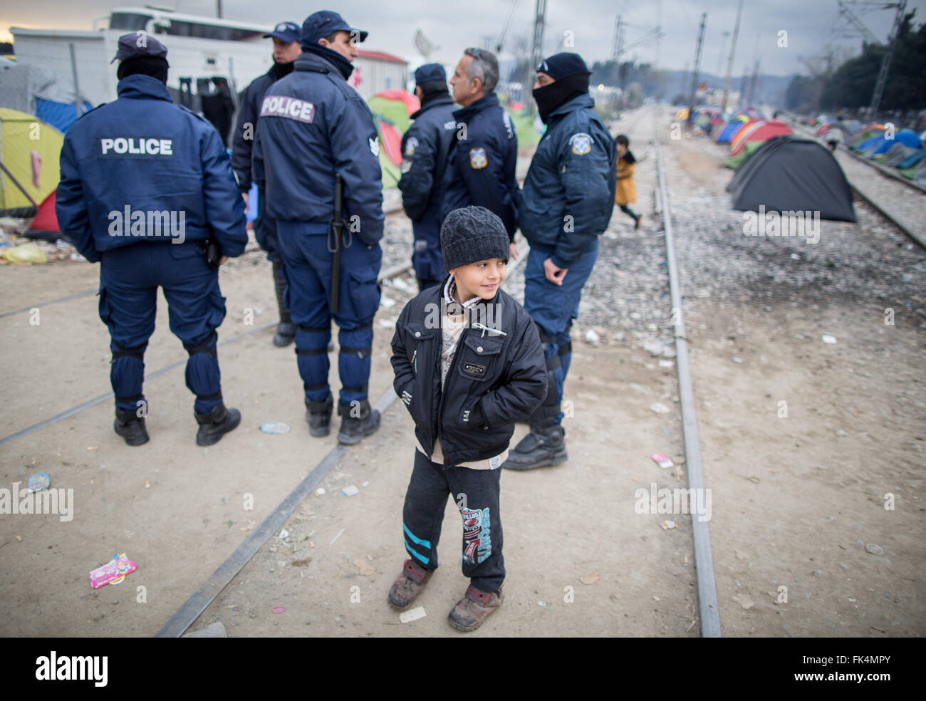 Idomeni, Greece. 07th Mar, 2016. A refugee boy stands between Greek ...