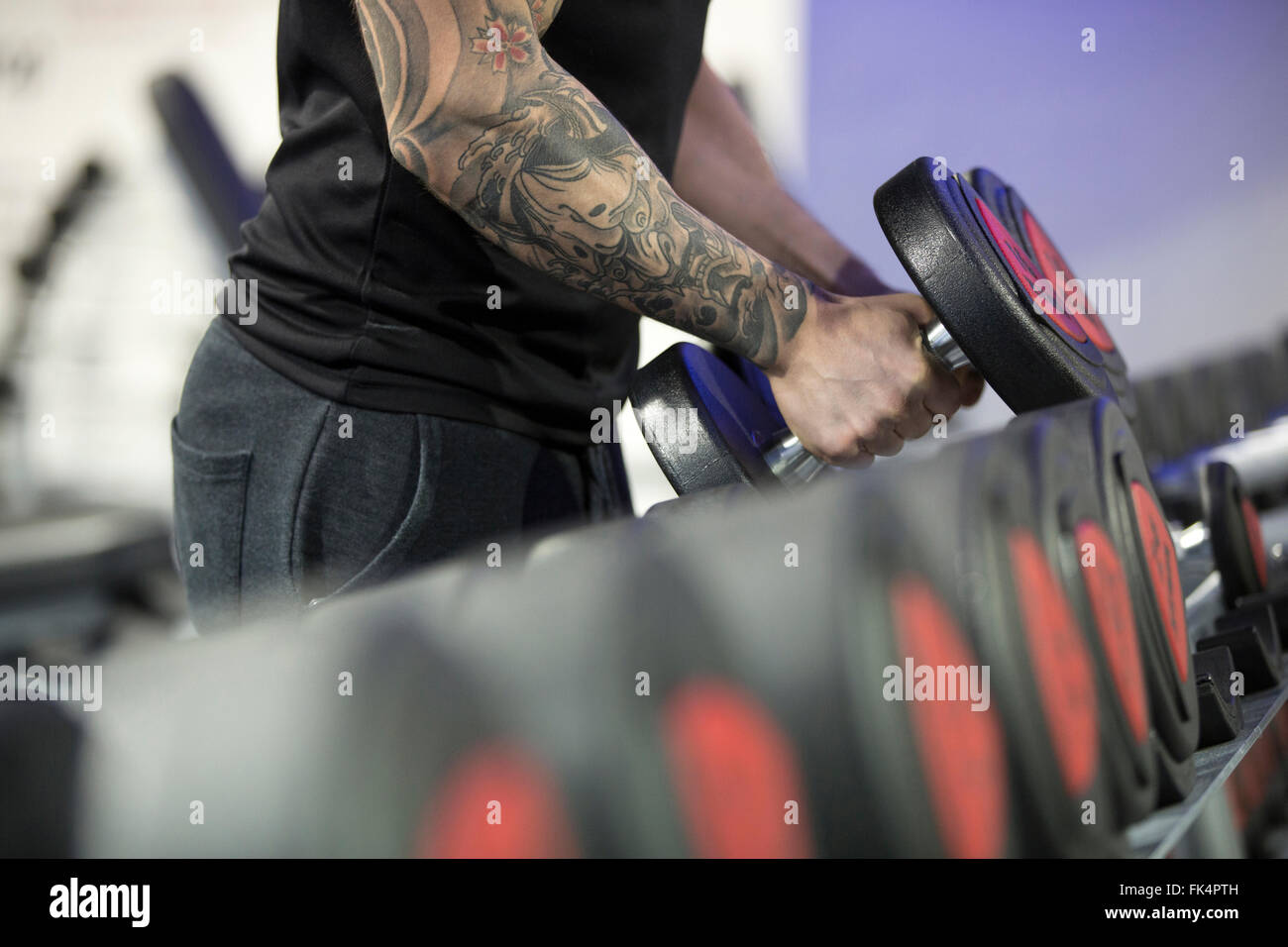 young man working out with weights in a gym Stock Photo - Alamy