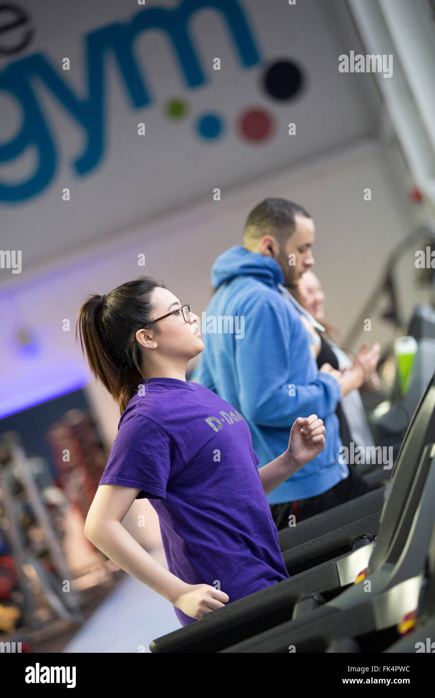 young people working out on running machines in a gym Stock Photo - Alamy