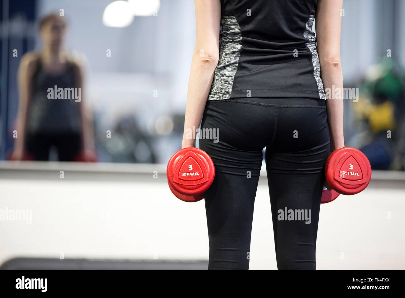 young woman working out with weights in a gym Stock Photo - Alamy
