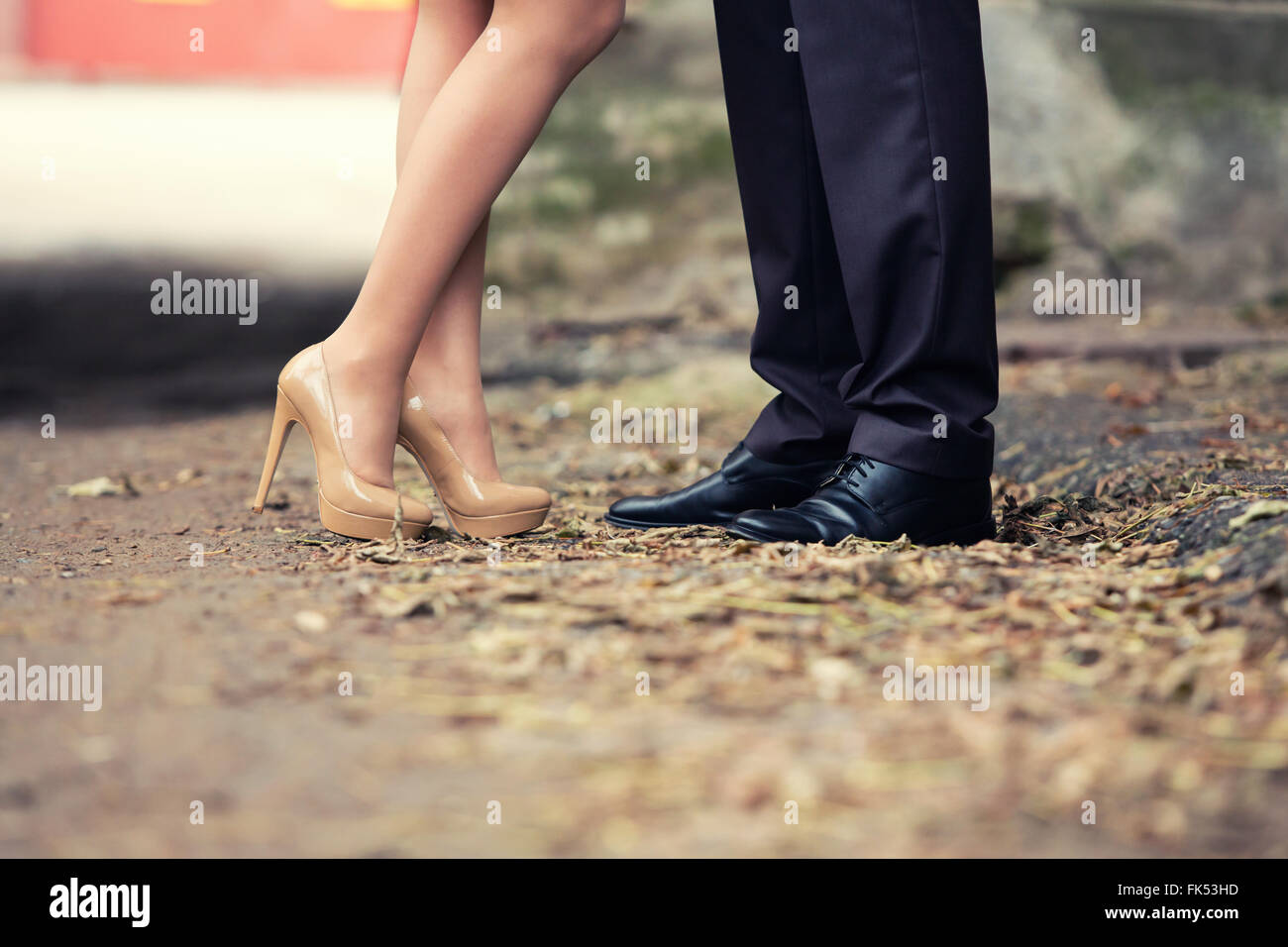 Closeup of male and female legs during a date Stock Photo - Alamy
