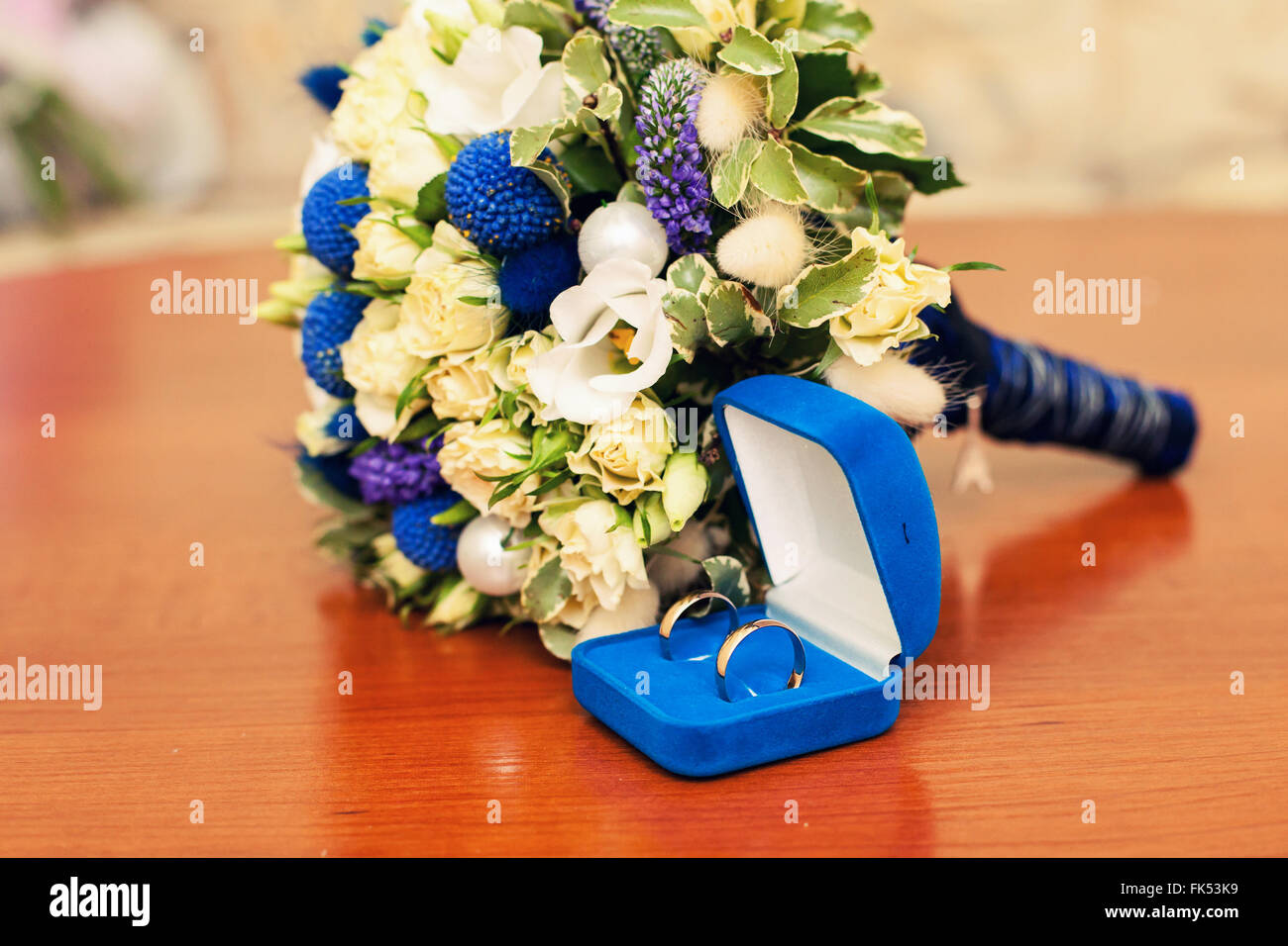 wedding rings in a blue box and a bridal bouquet Stock Photo - Alamy